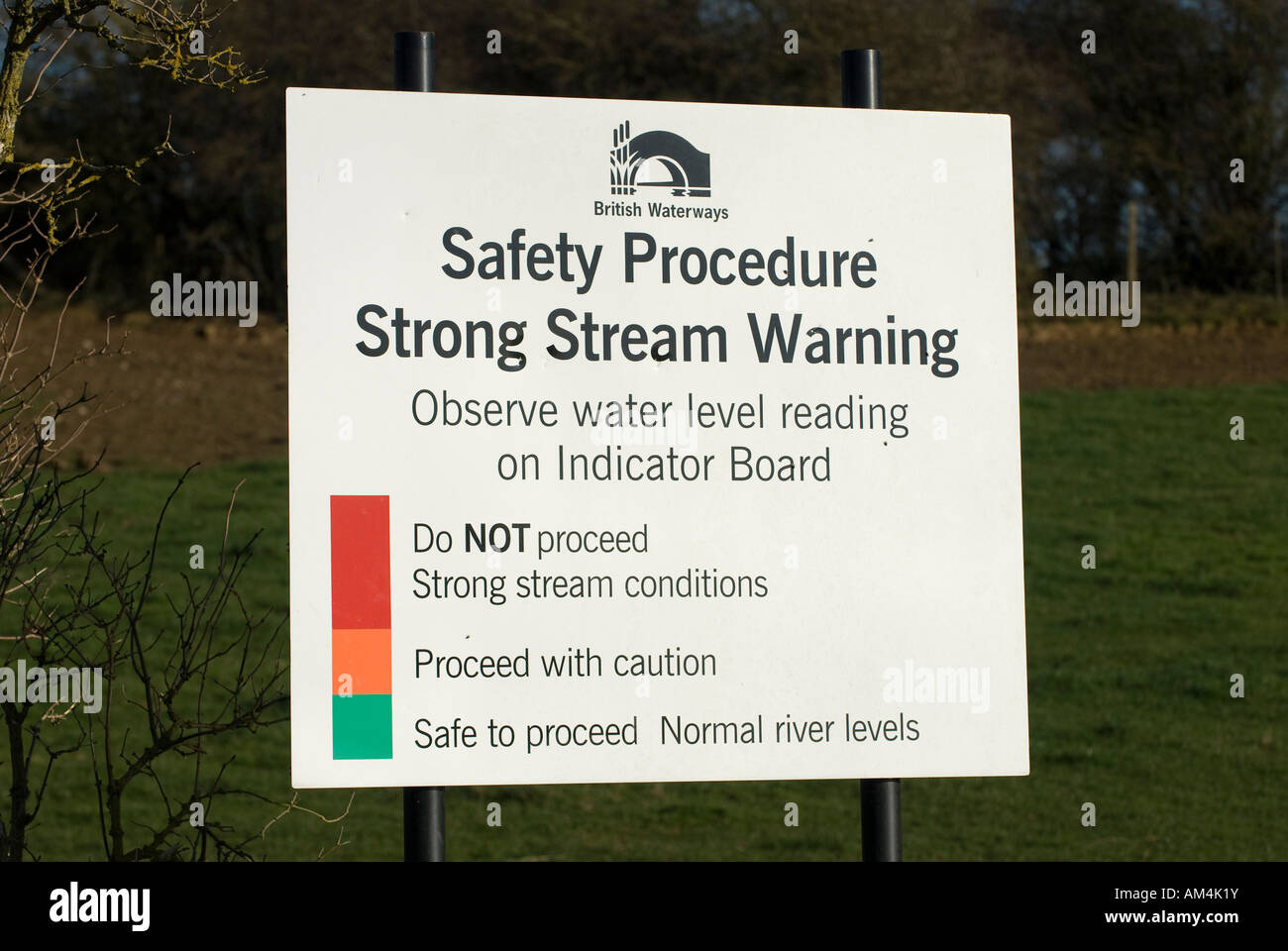 A saftey notice on a canal indicating to be aware of water level and ...