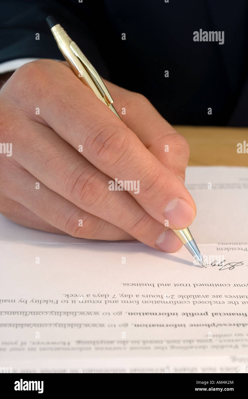 Businessman signing a document Stock Photo - Alamy