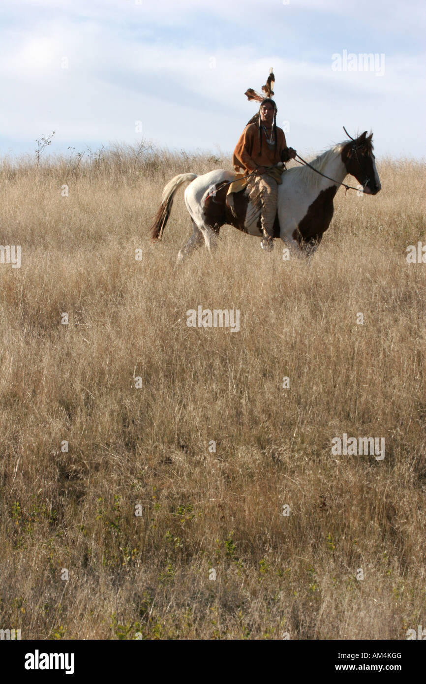 A Native American Indian man riding horseback scouting for enemies or ...