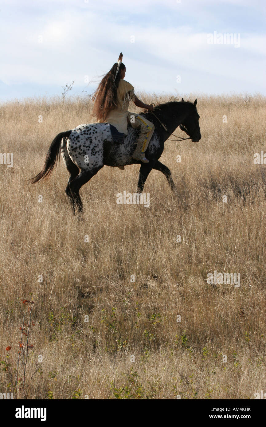 A Native American Indian man riding horseback scouting for enemies or ...