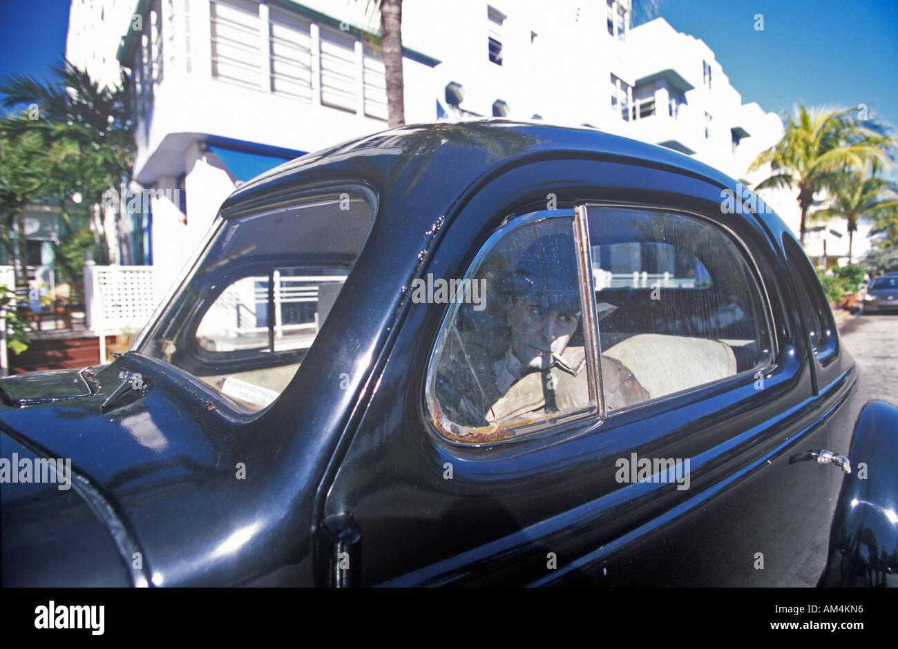 Antique car with caricature of Humphrey Bogart driving in south beach ...