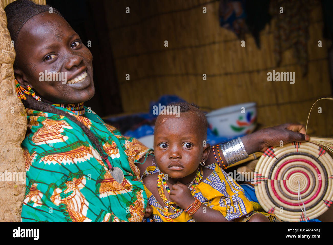 A Fulani woman in Niger, West Africa, holds a calabash cover that she ...