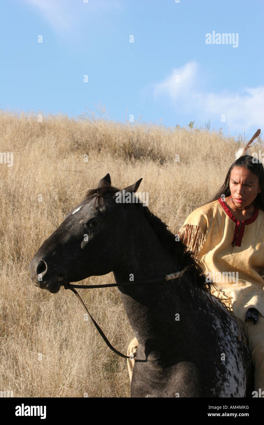 A Native American Indian boy on horseback riding an Appaloosa horse in ...