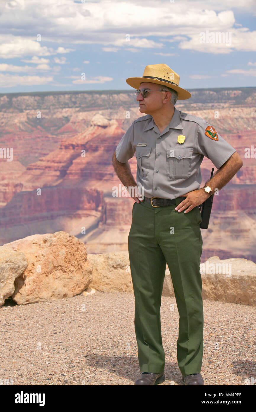 Female National Park ranger looking at South Rim of Grand Canyon ...