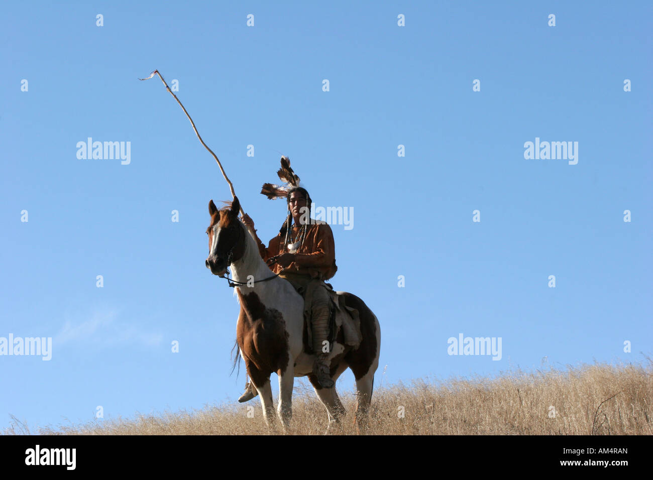 A Native American Indian man siting bareback on a horse riding the ...
