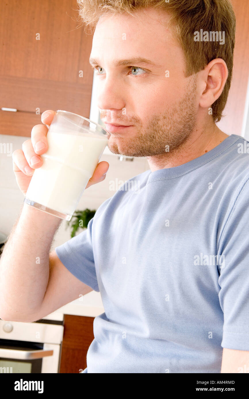 man drinking milk in the kitchen Stock Photo - Alamy
