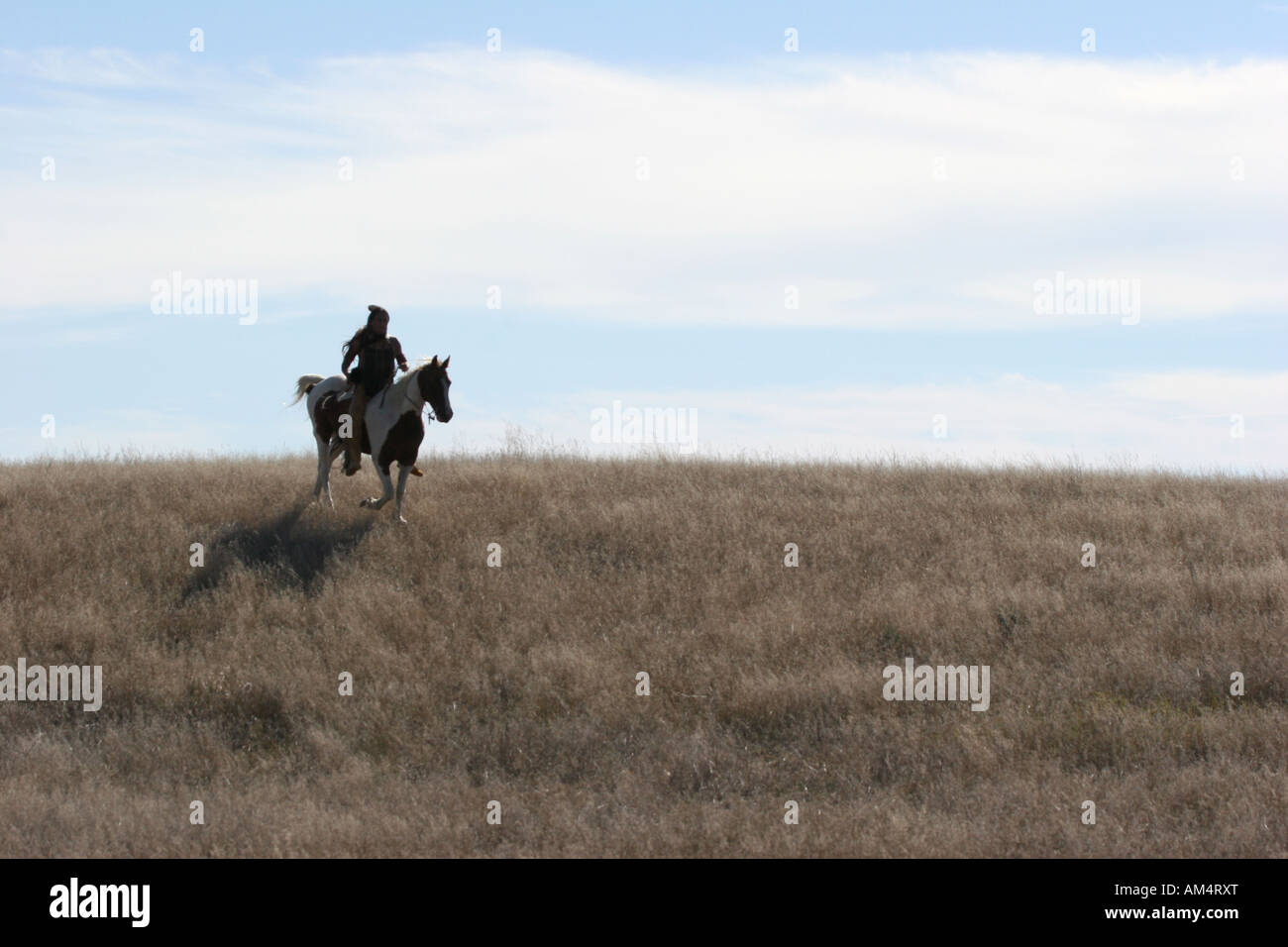 A Native American Indian silhouetted riding horseback looking for ...