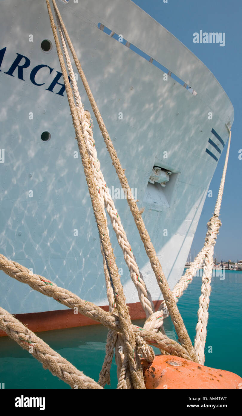 Moorings lines, green water and blue sky Stock Photo - Alamy