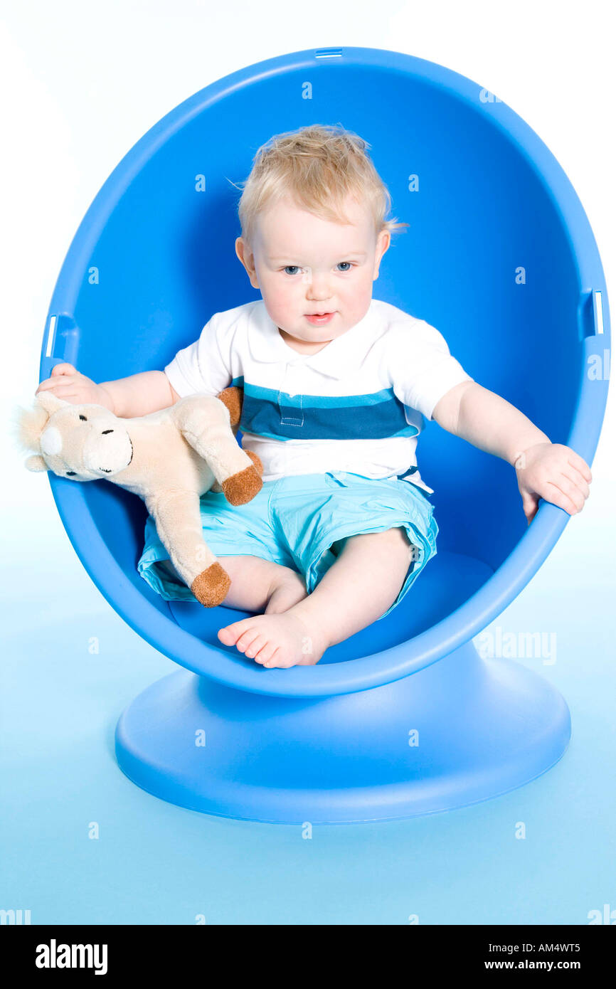 small boy sitting in chair Stock Photo - Alamy