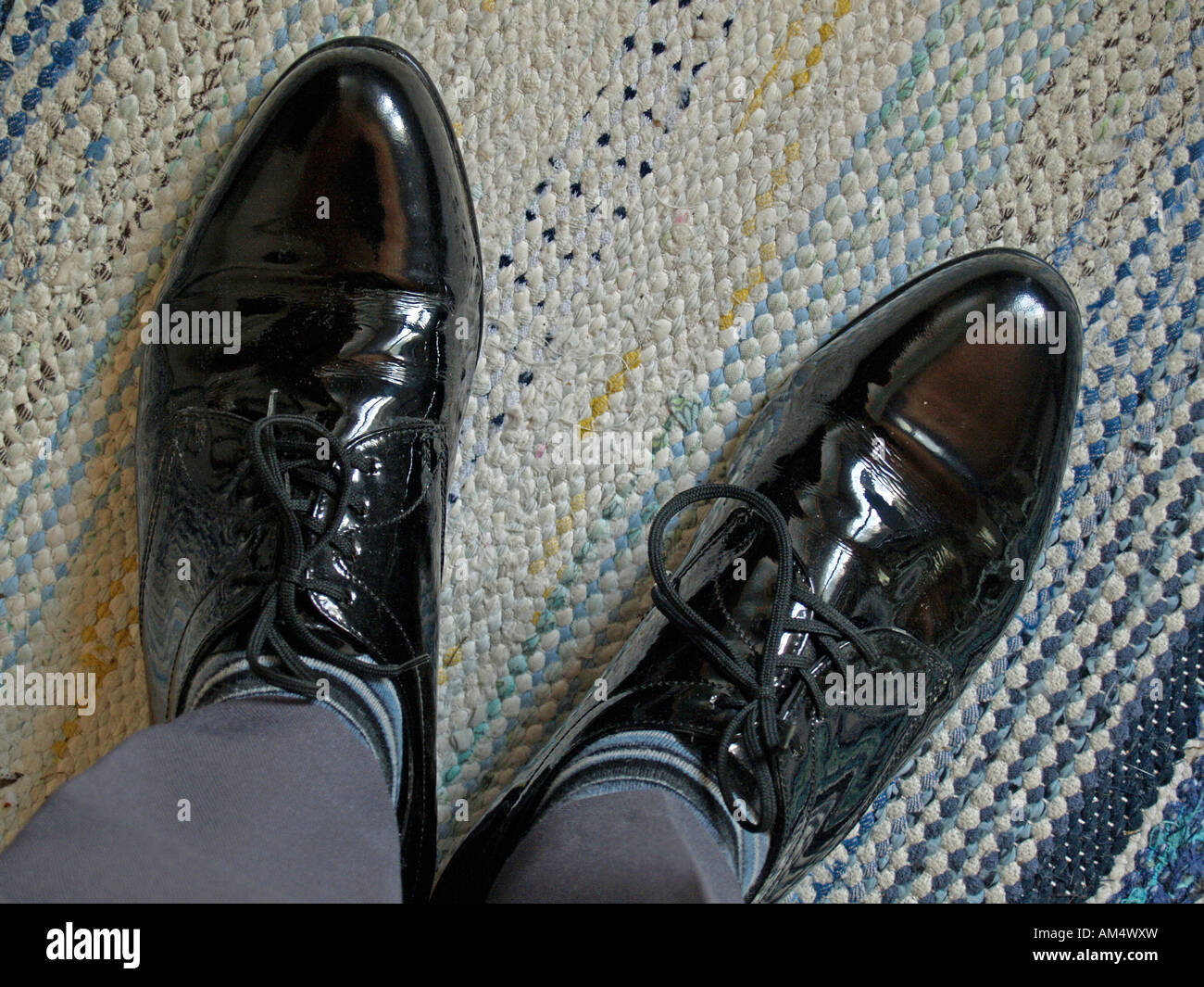 feet on carpet in black patent leather shoes Stock Photo - Alamy
