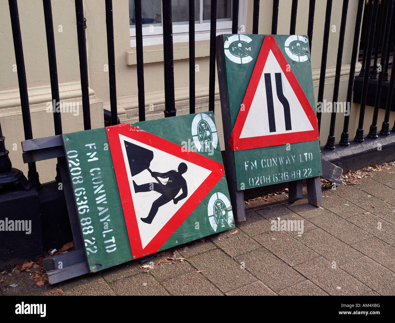 Road work signs left at the side of the pavement Stock Photo - Alamy