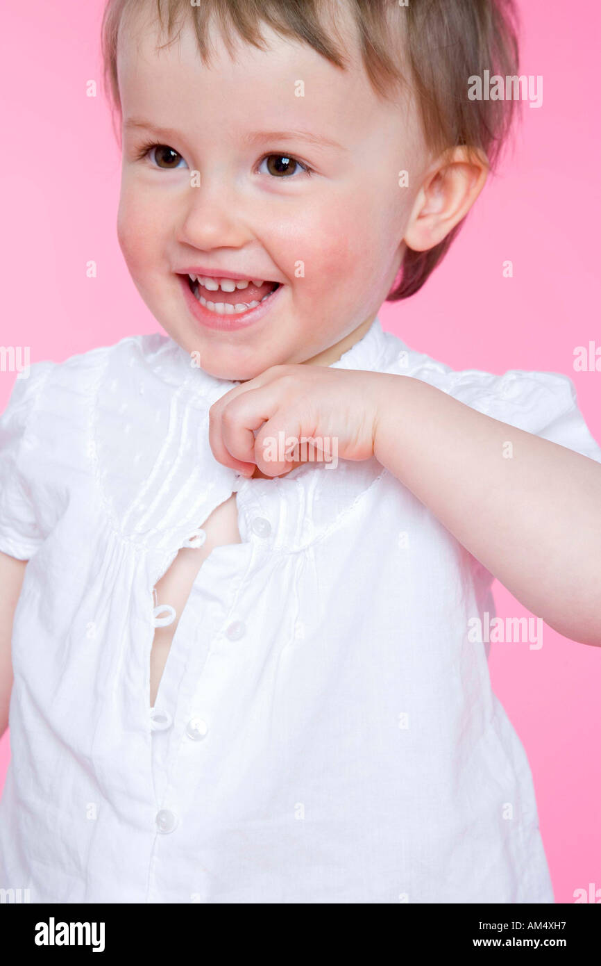 toddler girl putting up clothes Stock Photo - Alamy