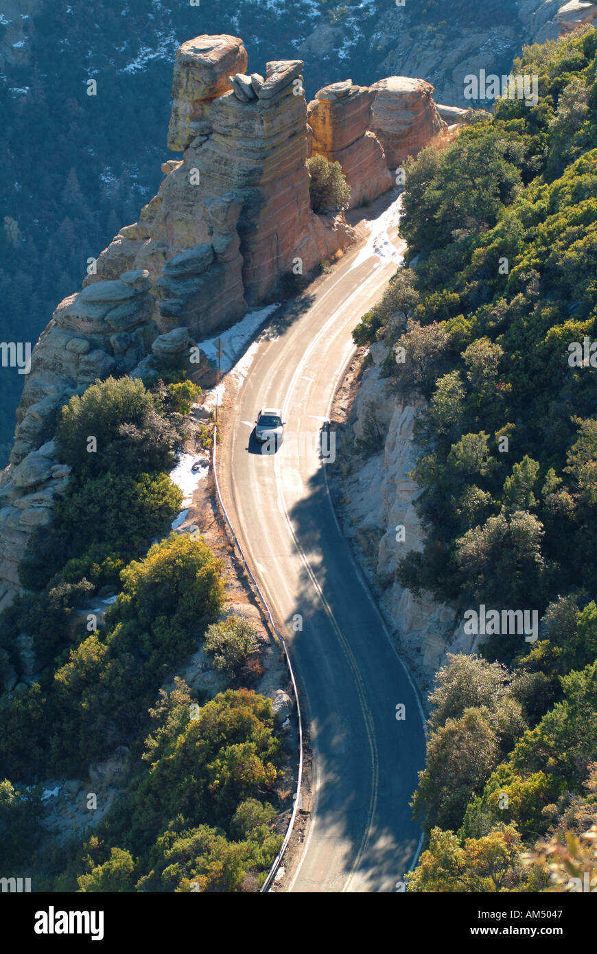 twisting mountain road with a car going around a switch back turn Stock ...