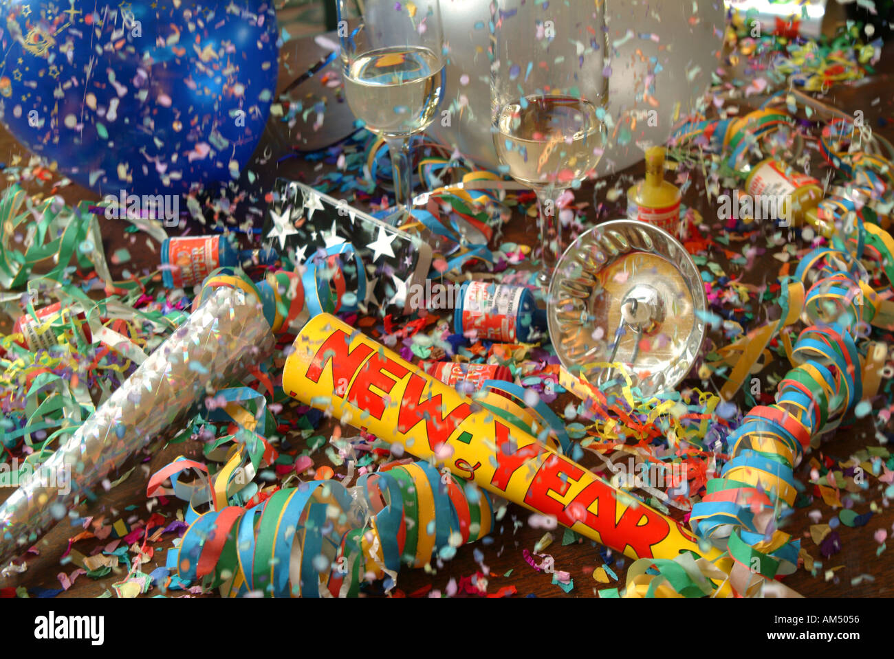 A wild New Years eve party showing confetti flying, horns, noise makers ...