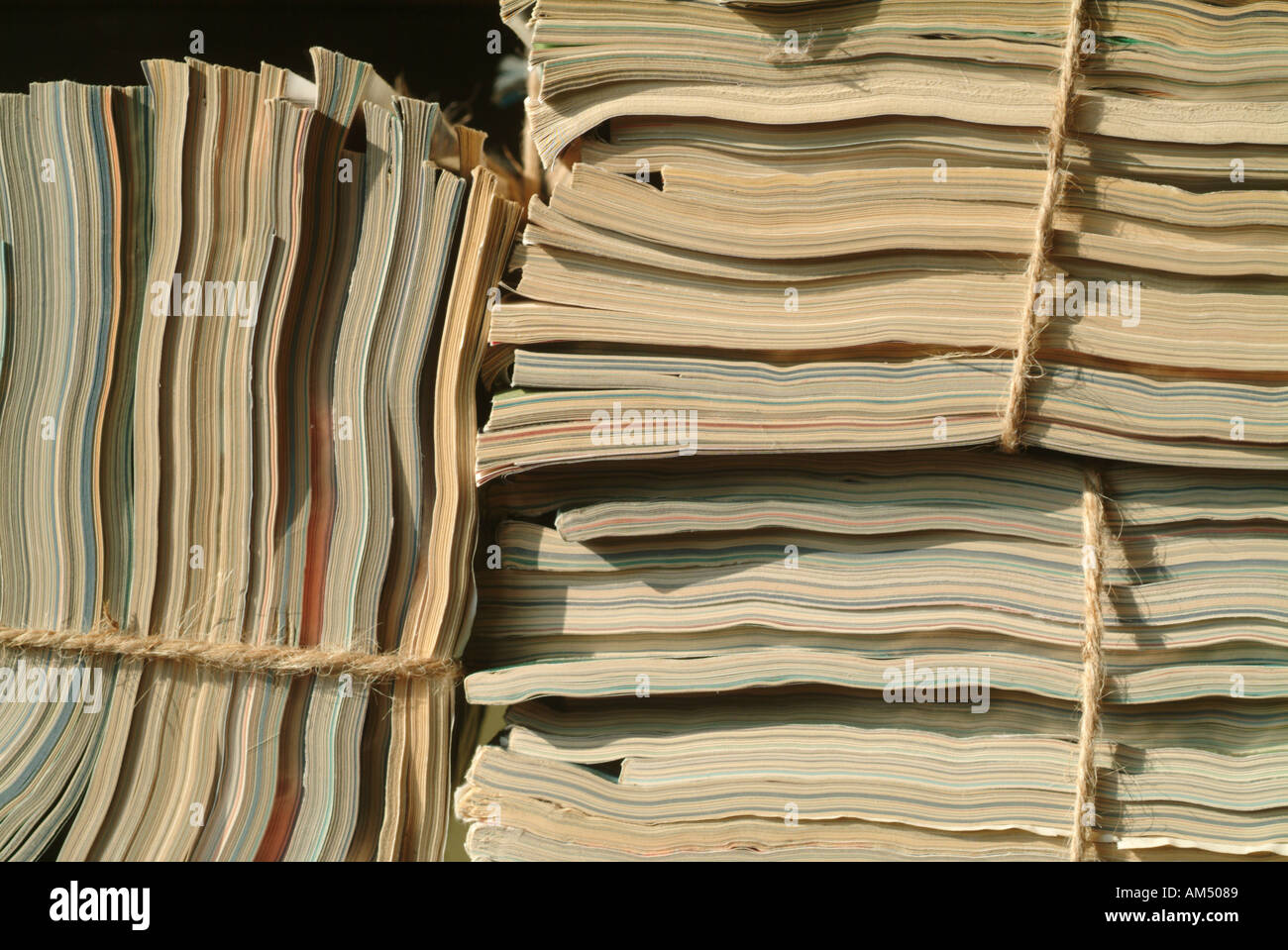 stack of magazines bound with string and ready to be put out for ...