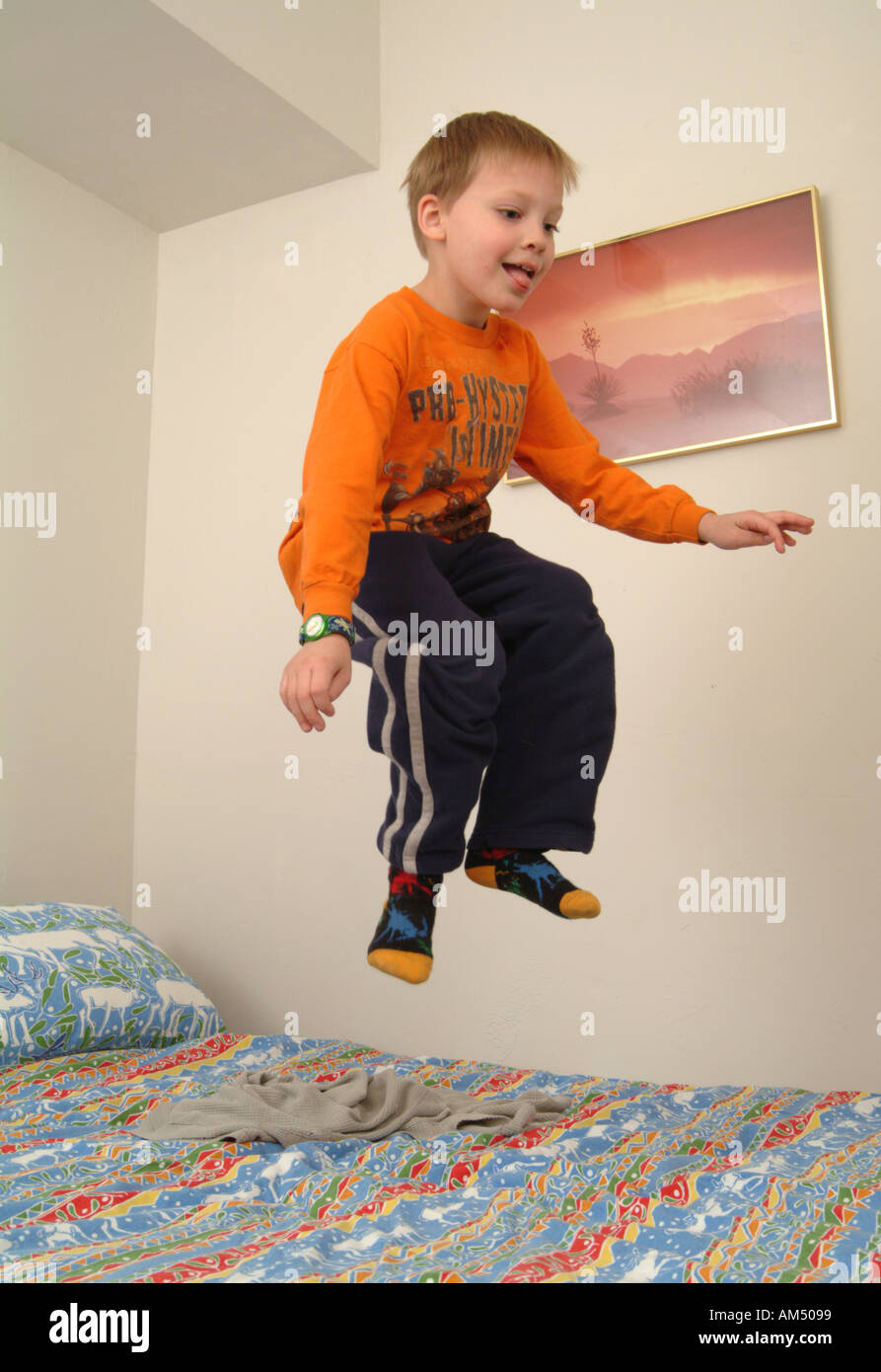 young boy jumping on his bed Stock Photo - Alamy