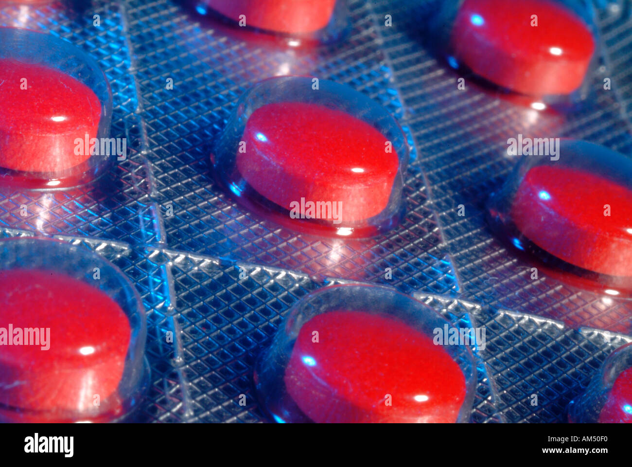 red medicine tablets in a foil blister package Stock Photo - Alamy
