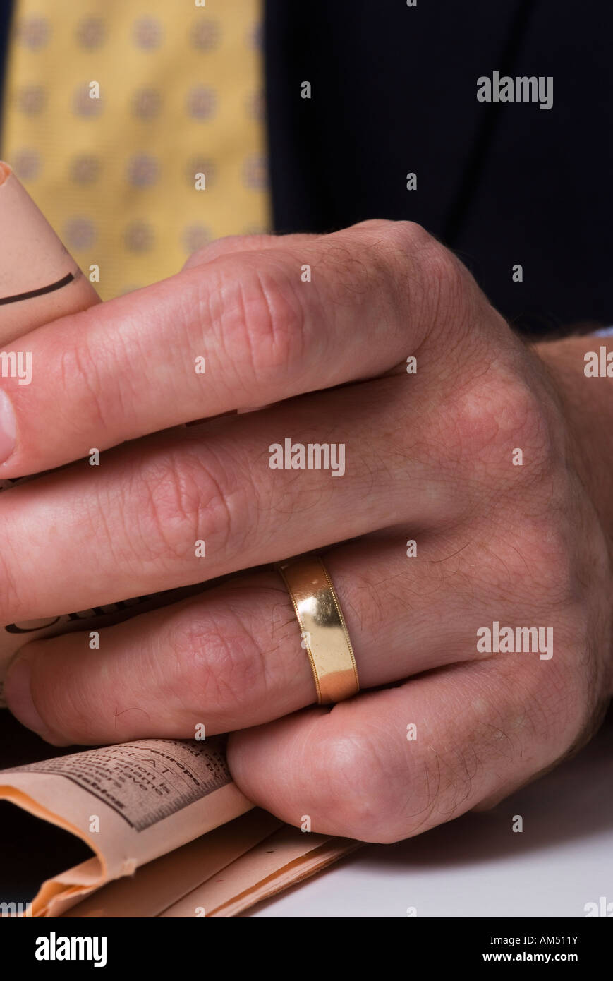 Close shot of business man reading paper showing hand and part of paper ...