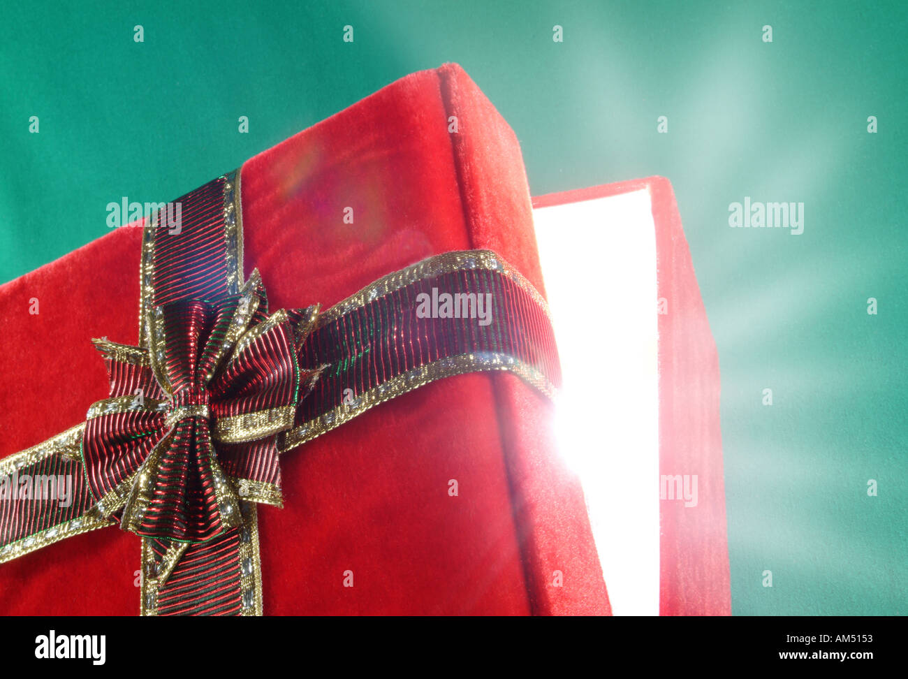 red gift box with lid ajar and rays of light bursting out Stock Photo ...