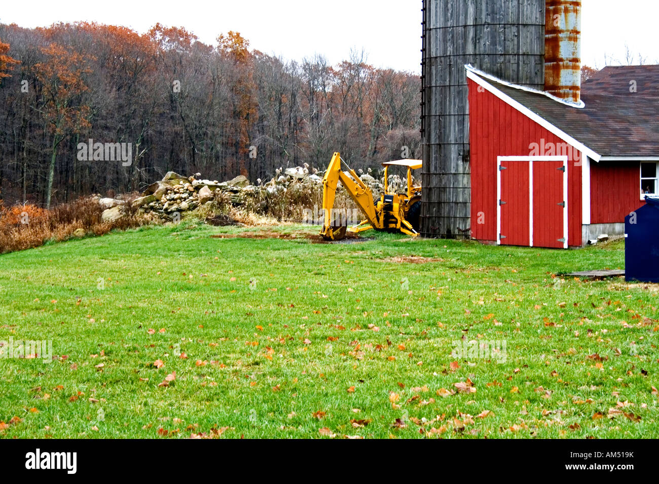 Payloader hiding behind a barn in Massachusetts Stock Photo - Alamy