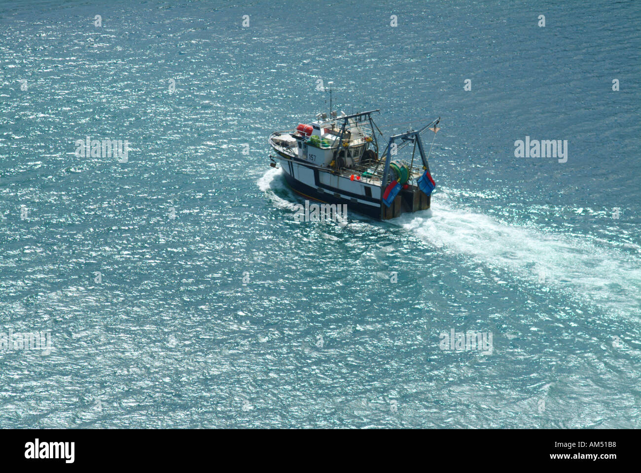 Purse seining fishing boat steams out to sea Stock Photo - Alamy