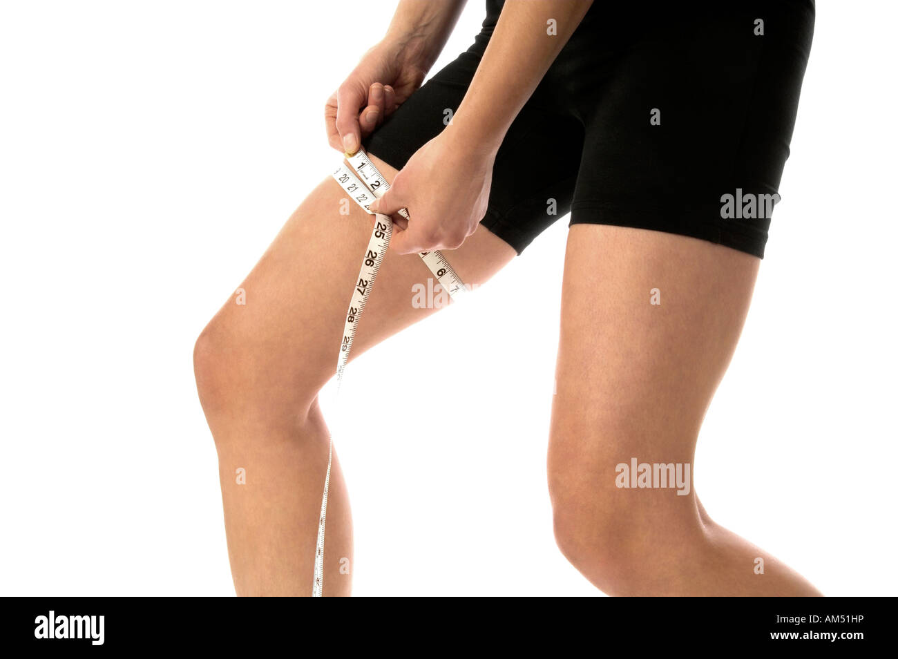 Young woman measuring thigh Stock Photo - Alamy
