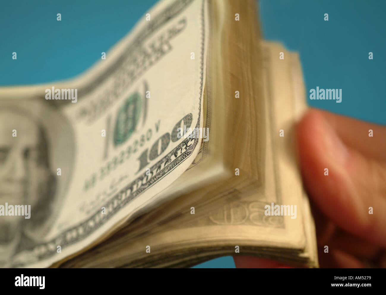 Thumbing A Thick Stack Of American Paper Money 100 Dollar Bills Stock thumbing-a-thick-stack-of-american-paper-money-100-dollar-bills-stock
