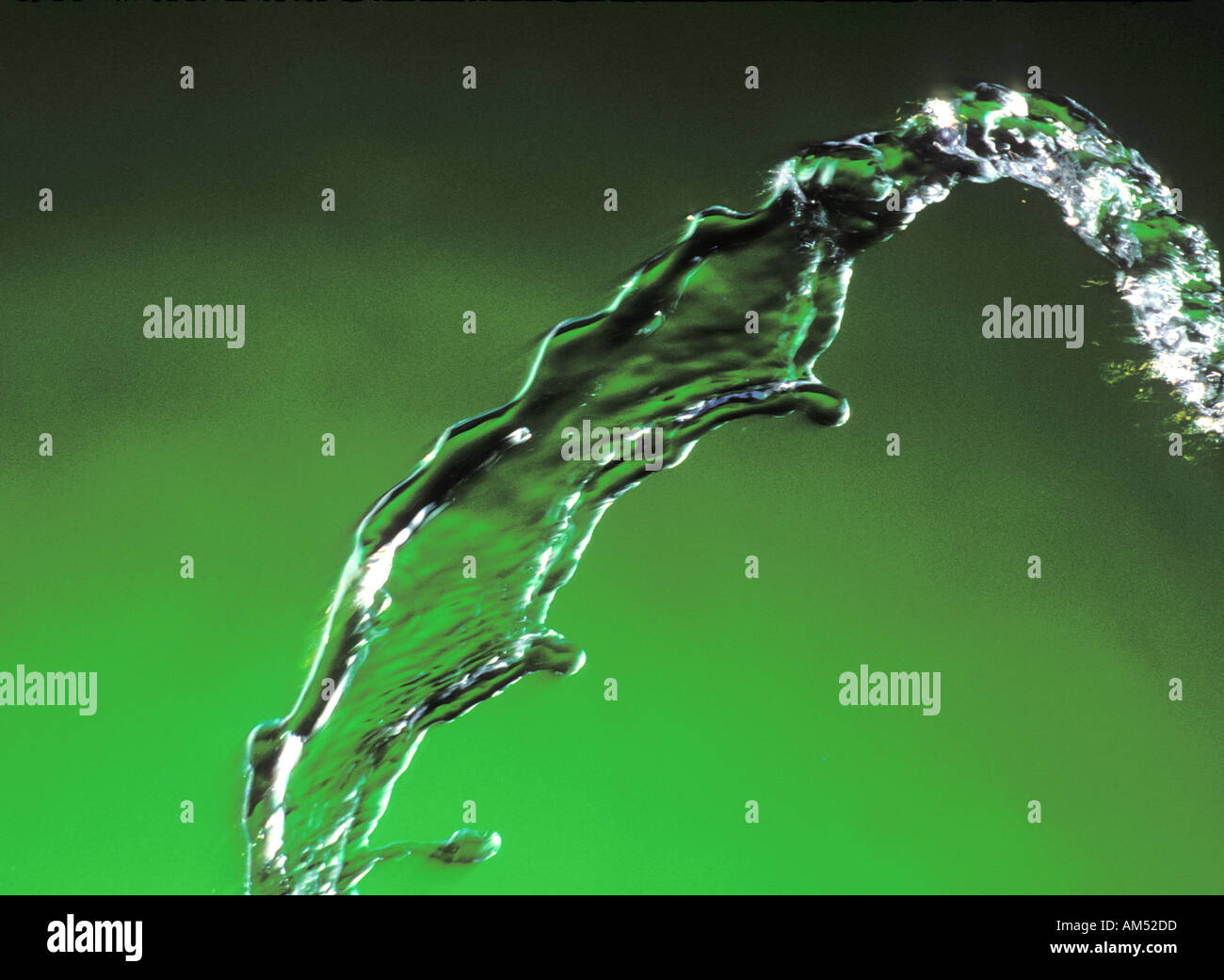 free- form column of water on a bright green background Stock Photo - Alamy