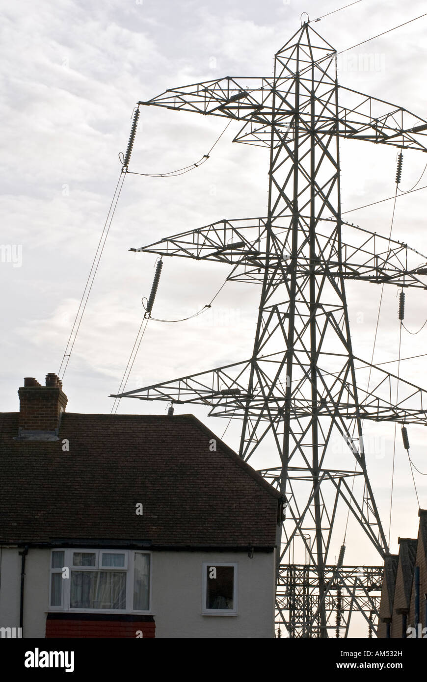 Electricity pylon semi detached house Stock Photo - Alamy