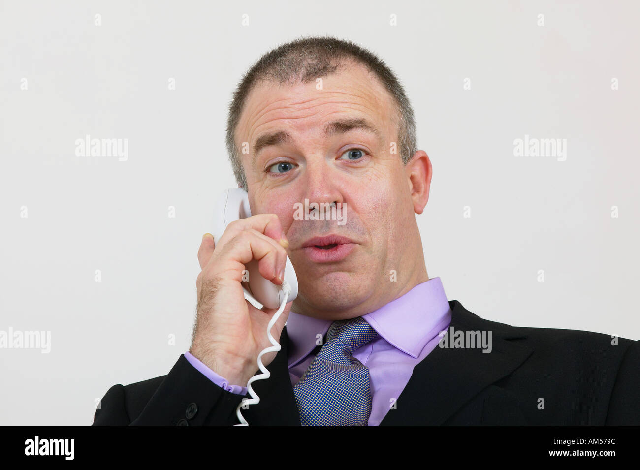 Businessman having animated conversation on telephone Stock Photo - Alamy