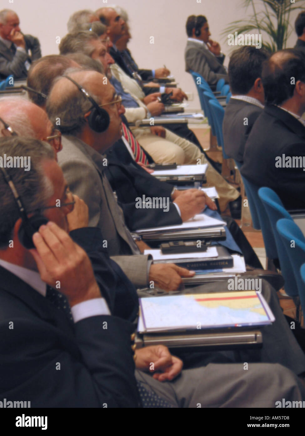Businessmen at a conference wearing Language Translation Head Phones ...
