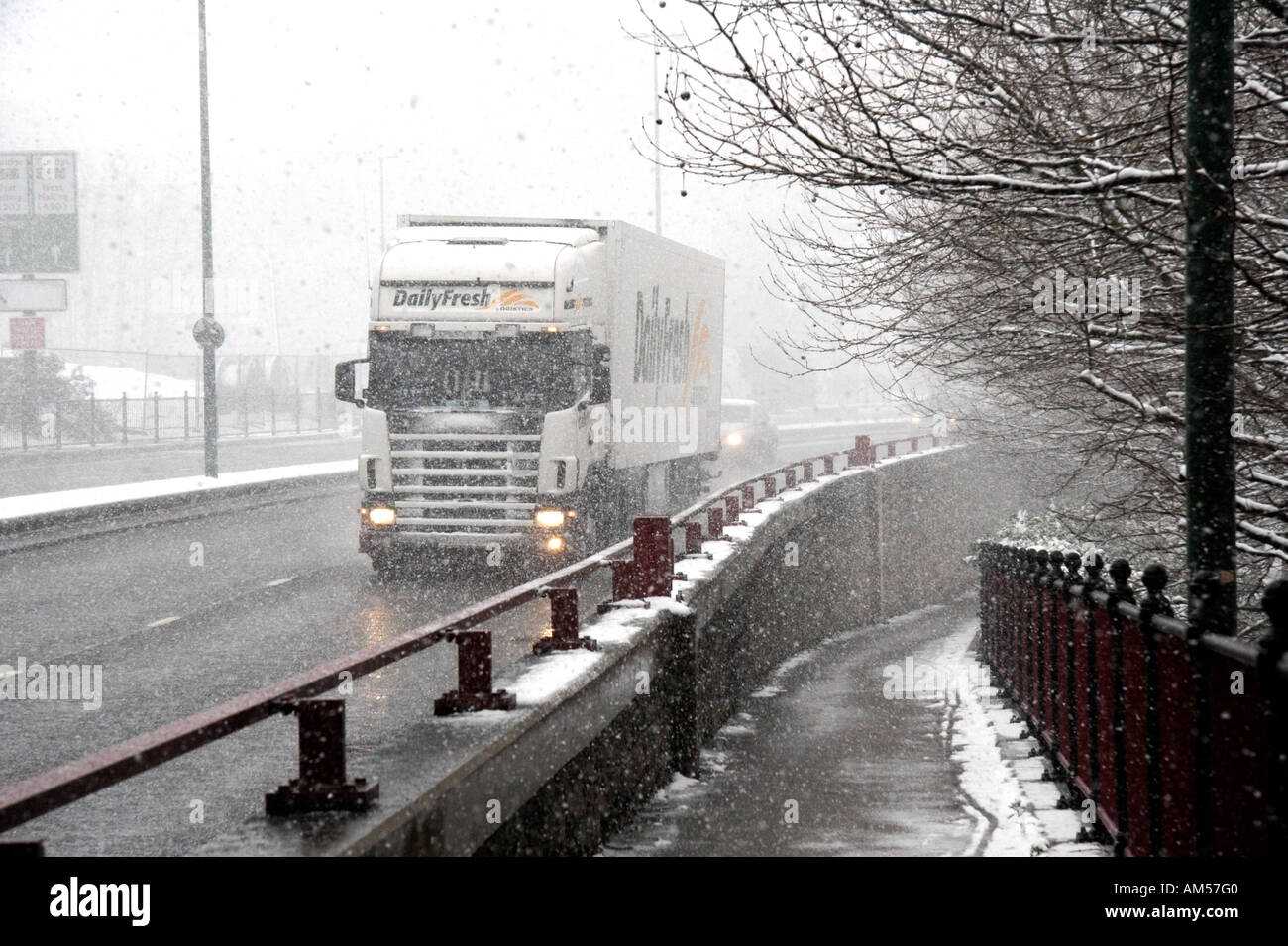 A lorry driving along a dual carrigeway during harsh winter driving ...