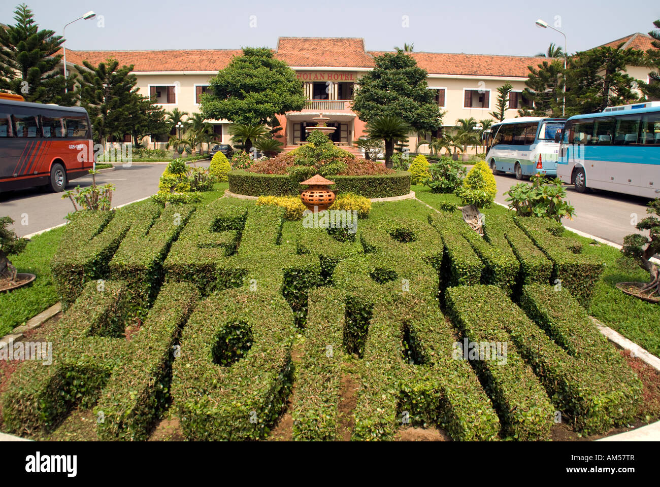 Hoi An Hotel welcome sign and tour busses Stock Photo - Alamy