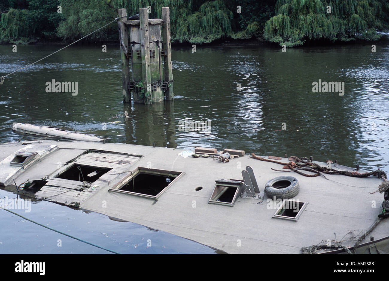 Half sunk boat at high tide on the River Thames Brentford Middlesex ...