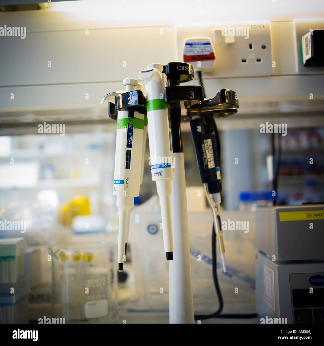 Laboratory work clinical trials research testing pipettes hanging on ...