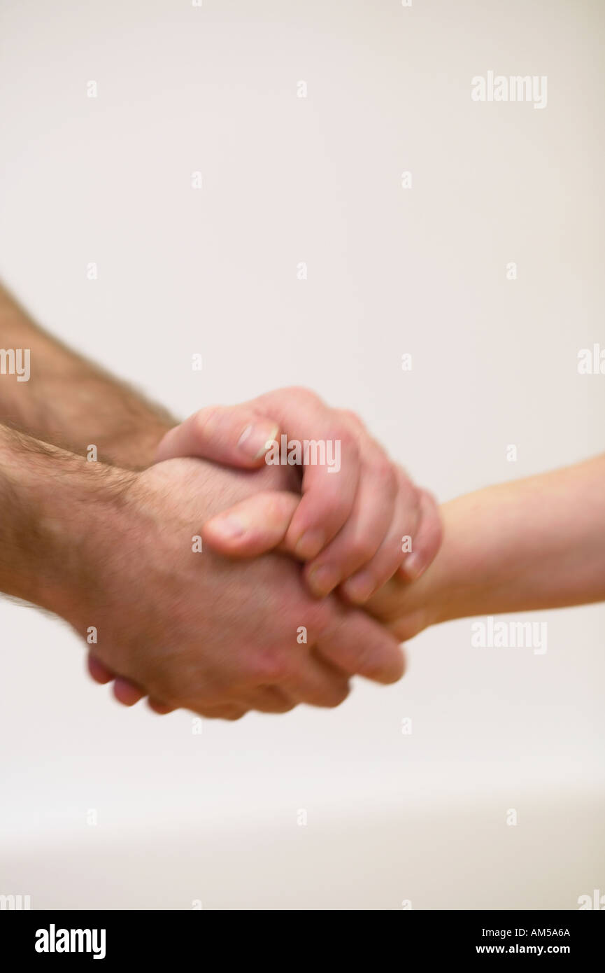Man and woman shaking hands on white background Stock Photo - Alamy