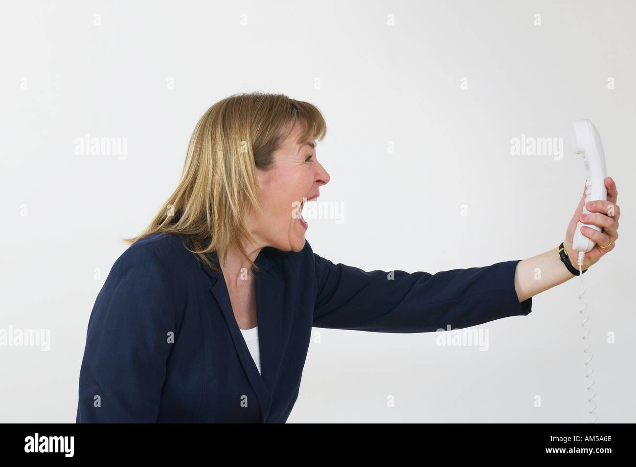 Woman shouting at telephone Stock Photo - Alamy