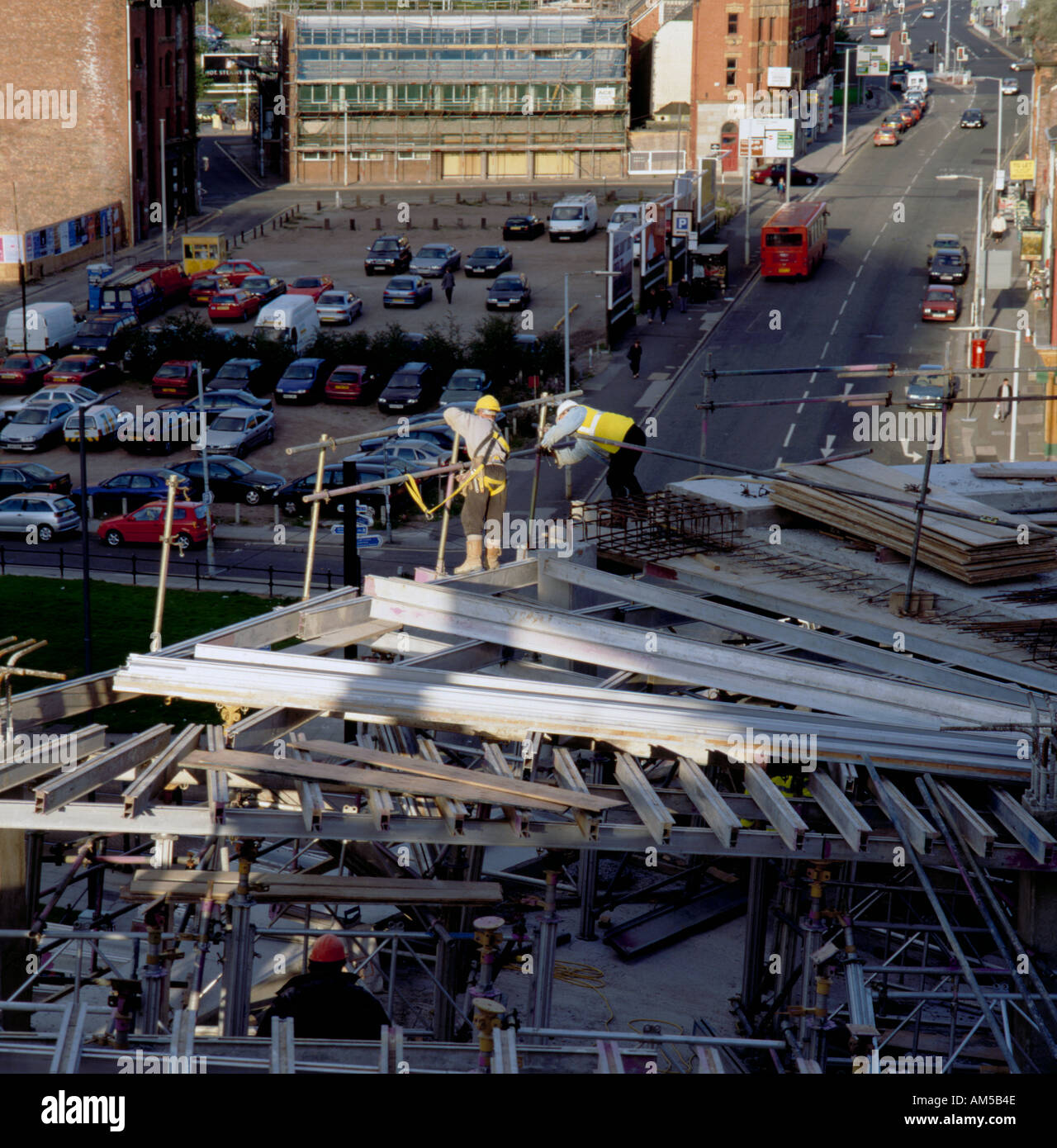 Workmen erecting a scaffolding safety barrier, atop the Arndale Centre ...
