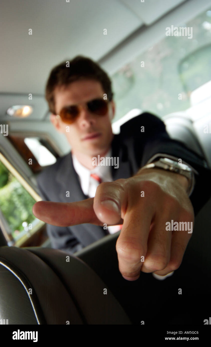 Business man pointing in car Stock Photo - Alamy