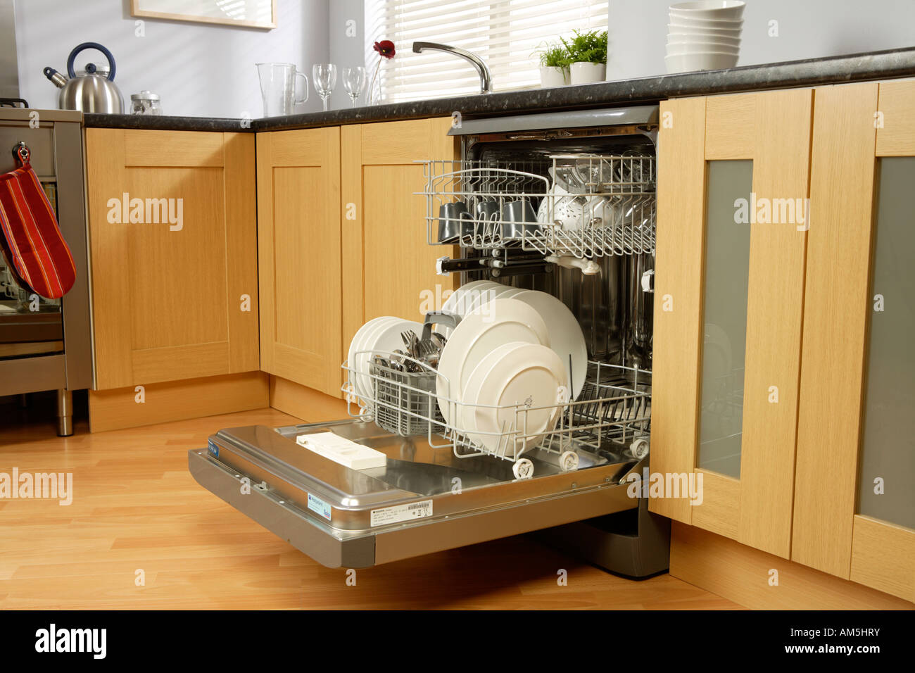 Full dishwasher in kitchen Stock Photo - Alamy