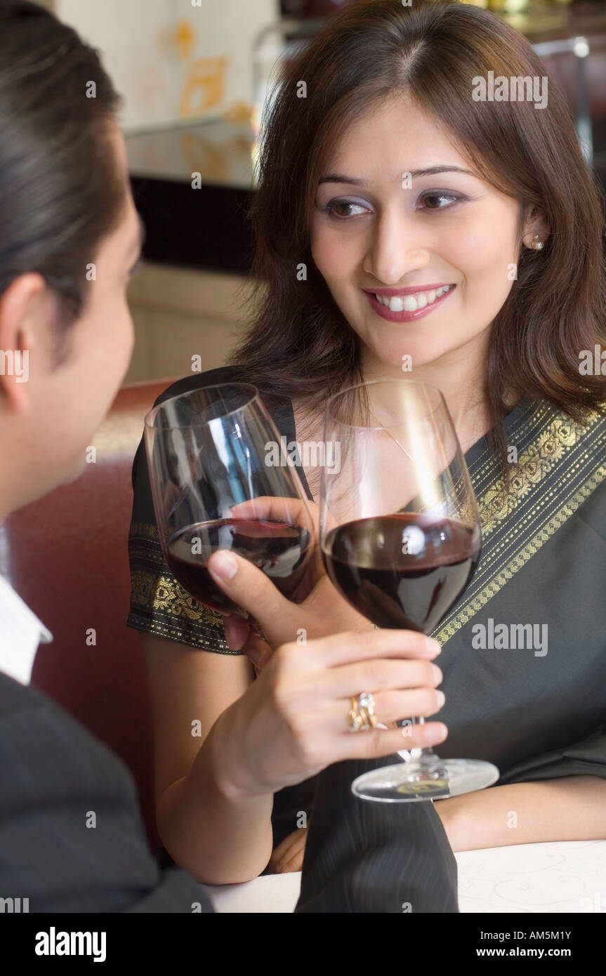 Sitting looking away smiling holding wine glass bonding celebration hi-res stock photography and ...