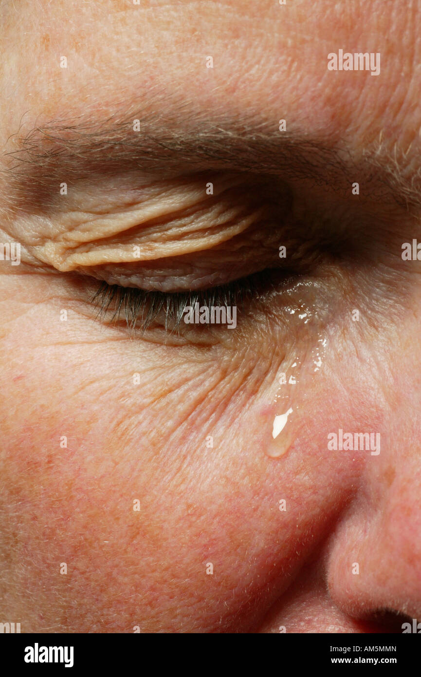 Eye with a teardrop Stock Photo - Alamy