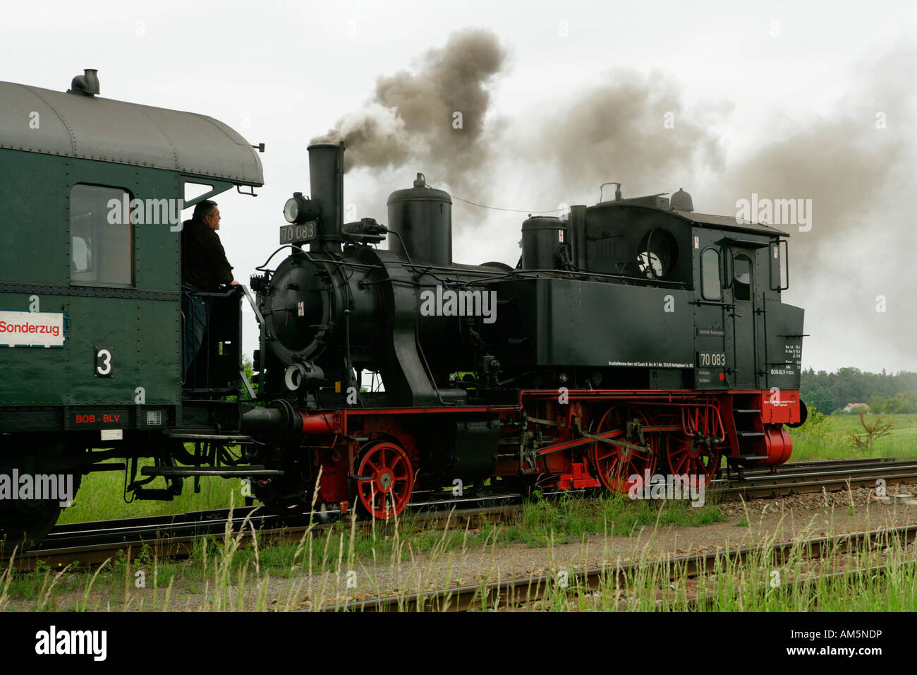 Historical steam train pushing a carriage Stock Photo - Alamy