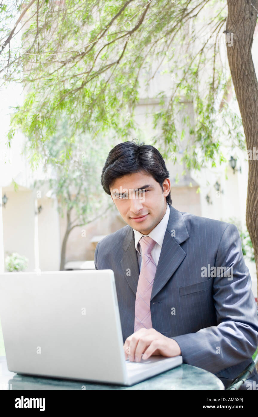 Portrait of a businessman using a laptop Stock Photo - Alamy