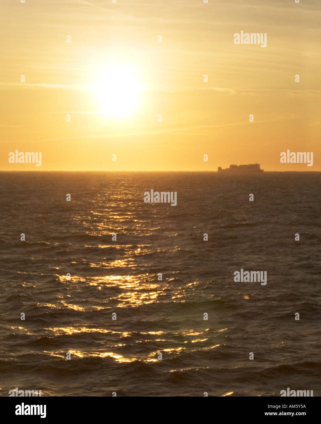 Passenger and car ferry against the sunset of Kattegat strait between ...