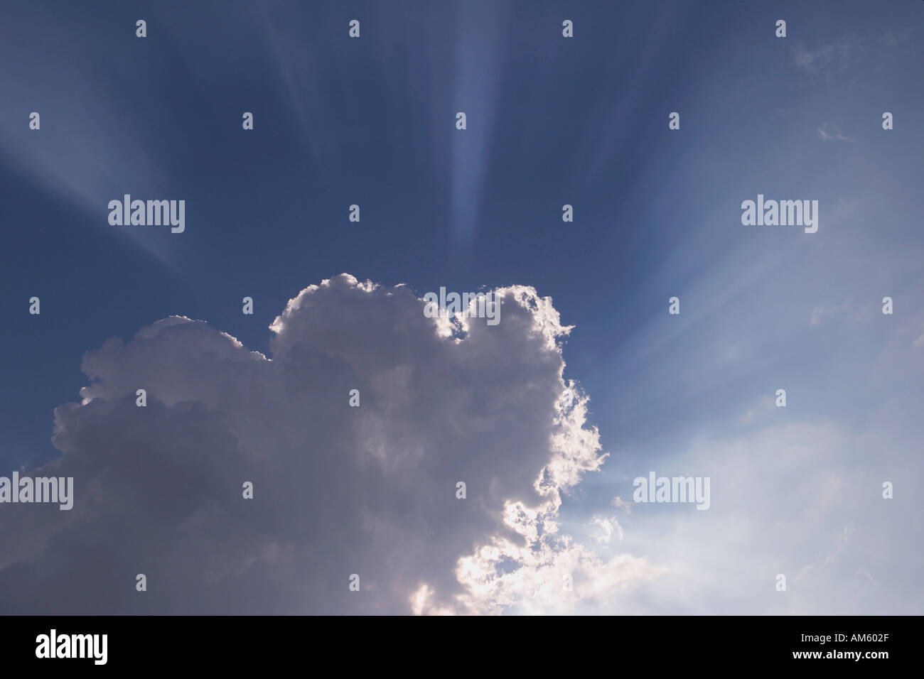 Sun rays bursting from behind cloud Stock Photo - Alamy