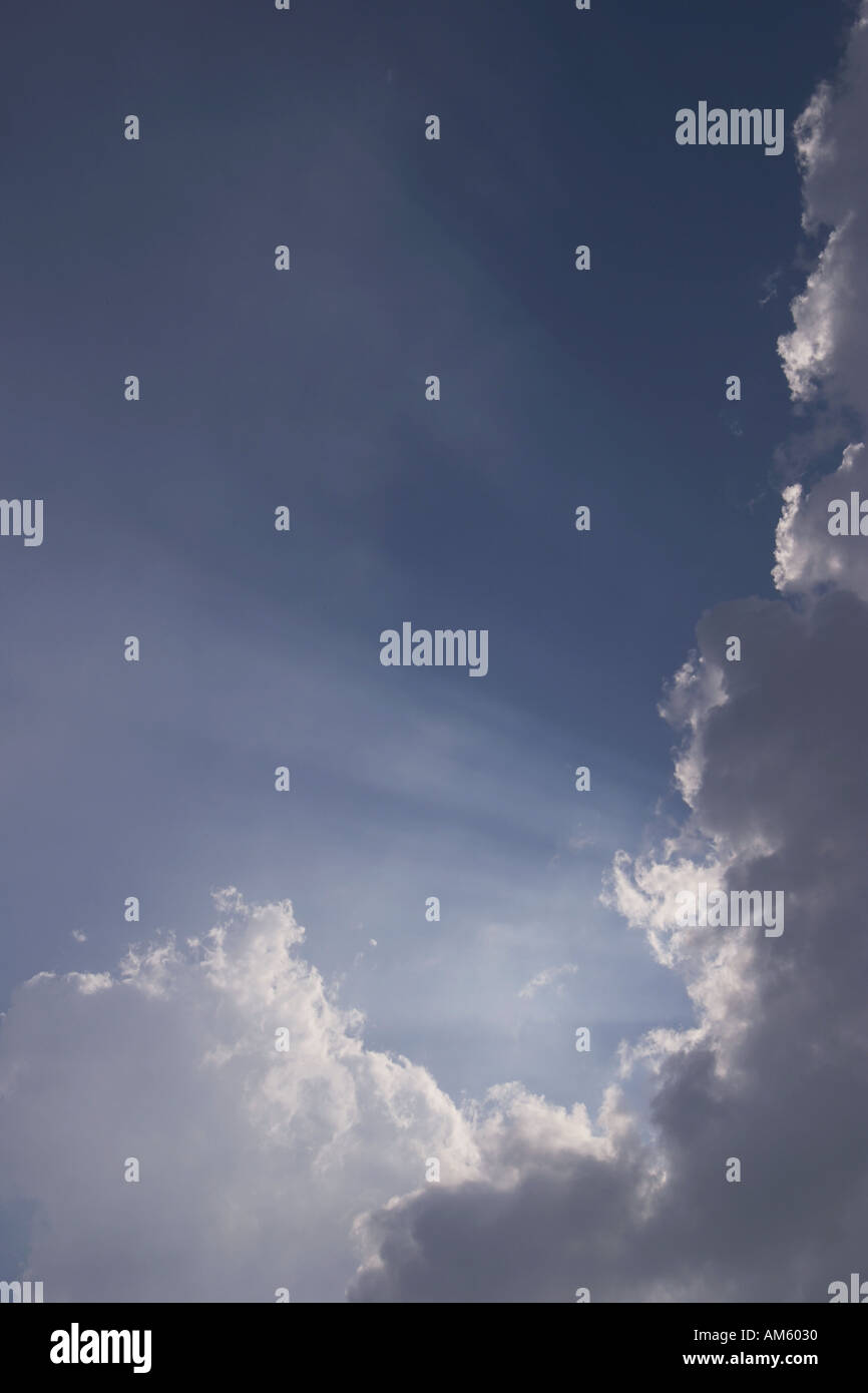 Sun rays bursting from behind cloud Stock Photo - Alamy