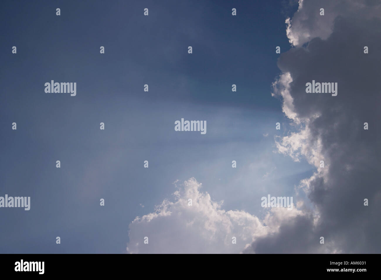 Sun rays bursting from behind cloud Stock Photo - Alamy