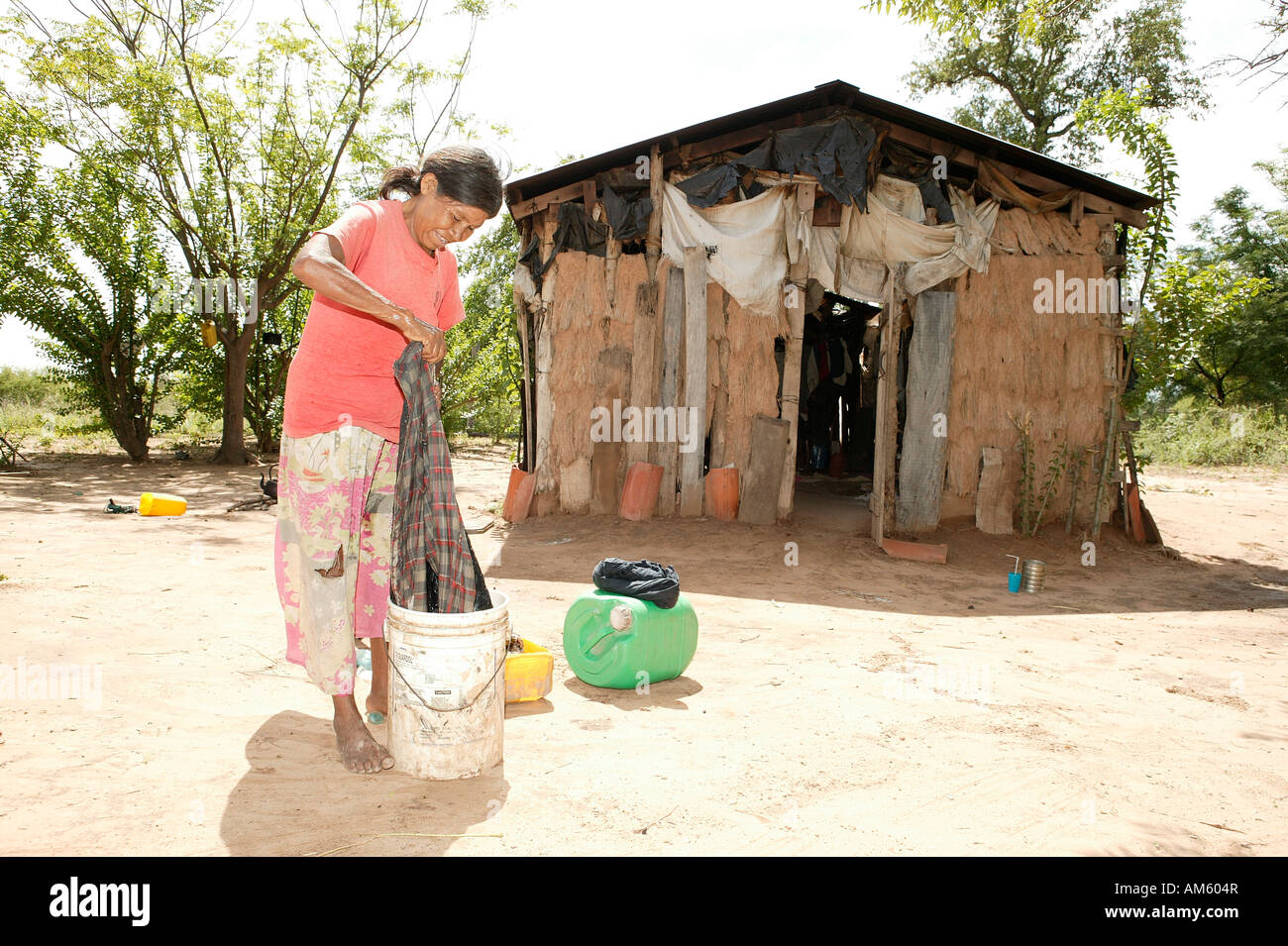 Woman washing clothes in front of her hut, Nivaclé native Americans ...