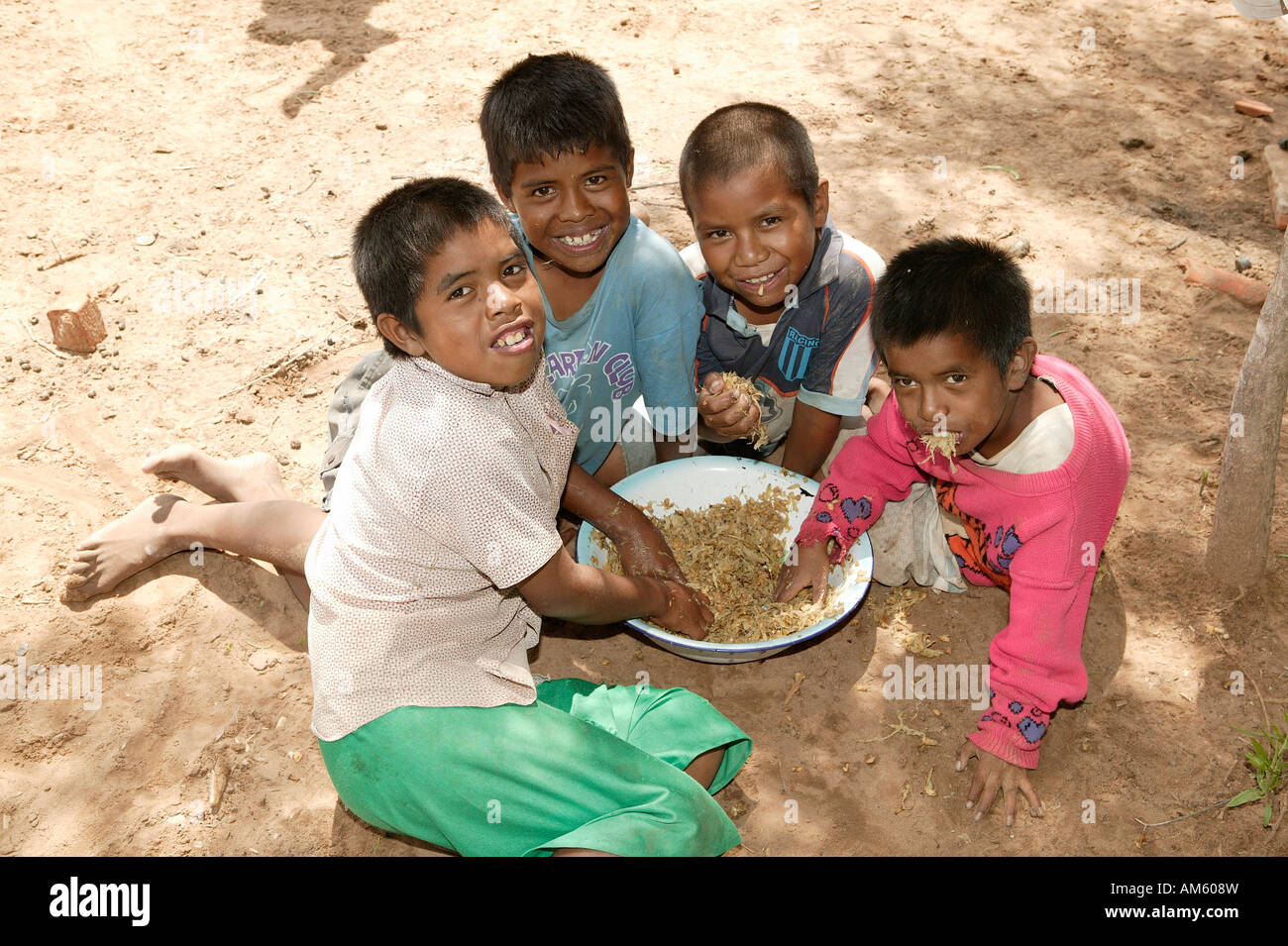 Children eating fresh, hackled sugar cane, Nivaclé native American ...